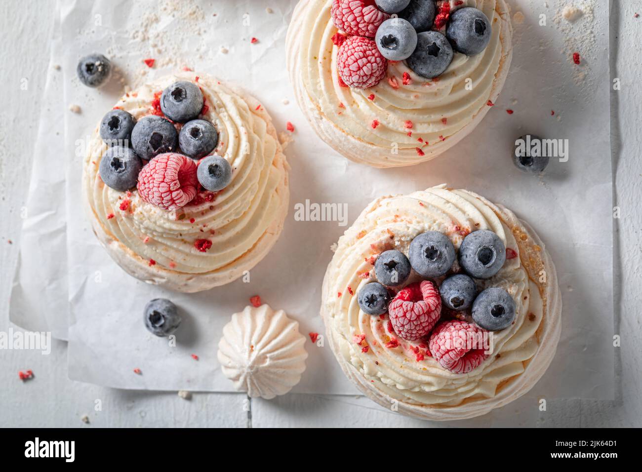 Creamy and sweet Pavlova dessert with berries and whipped cream. Mini ...