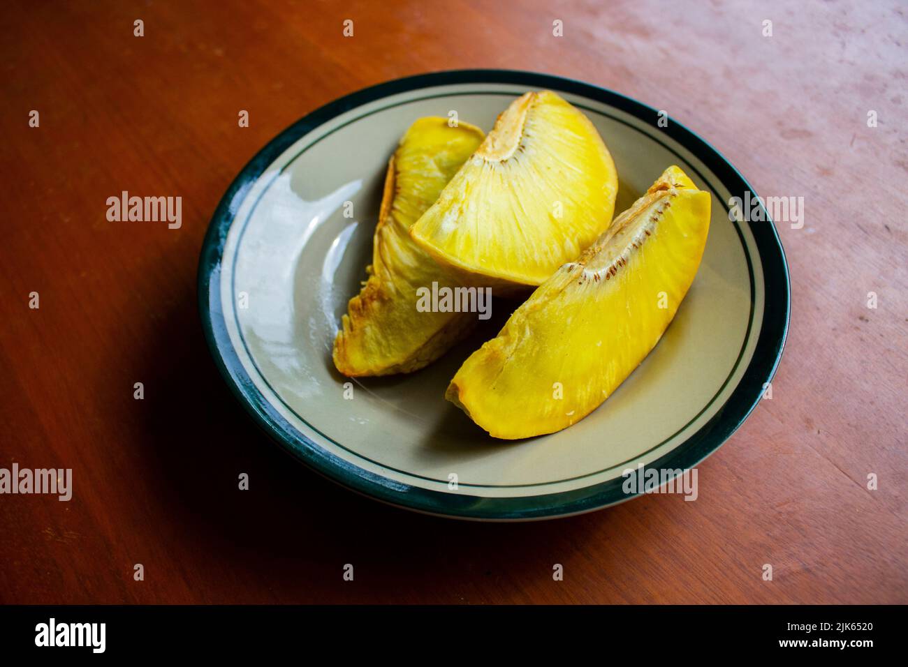 sukun goreng or fried breadfruit served at plate on black background Stock Photo - Alamy