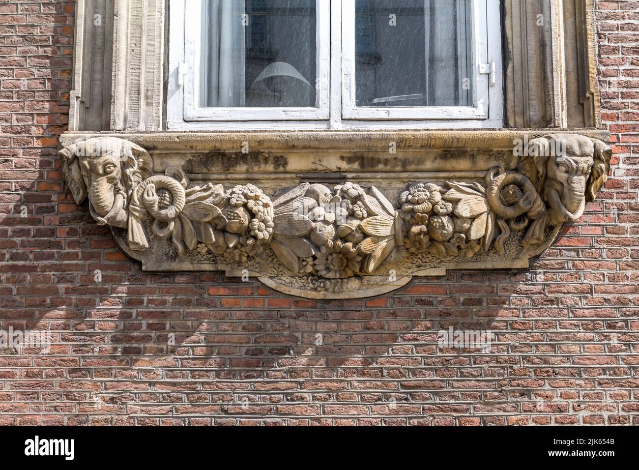detail of highly ornated window sill of historical brick building, shot ...
