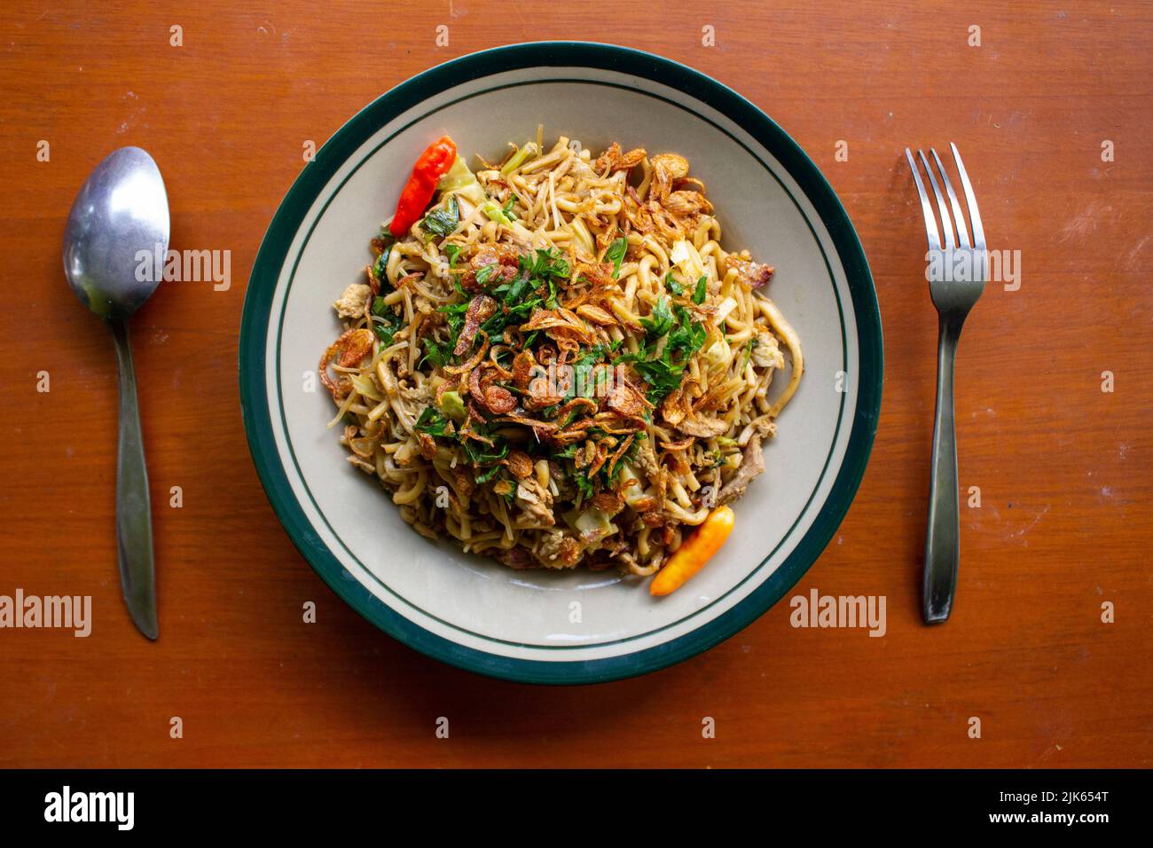 Mie Goreng Jawa or bakmi jawa or java noodle with spoon and fork ...