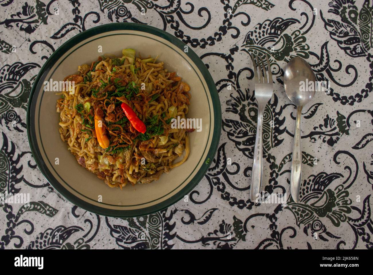 Mie Goreng Jawa or bakmi jawa or java noodle with spoon and fork ...