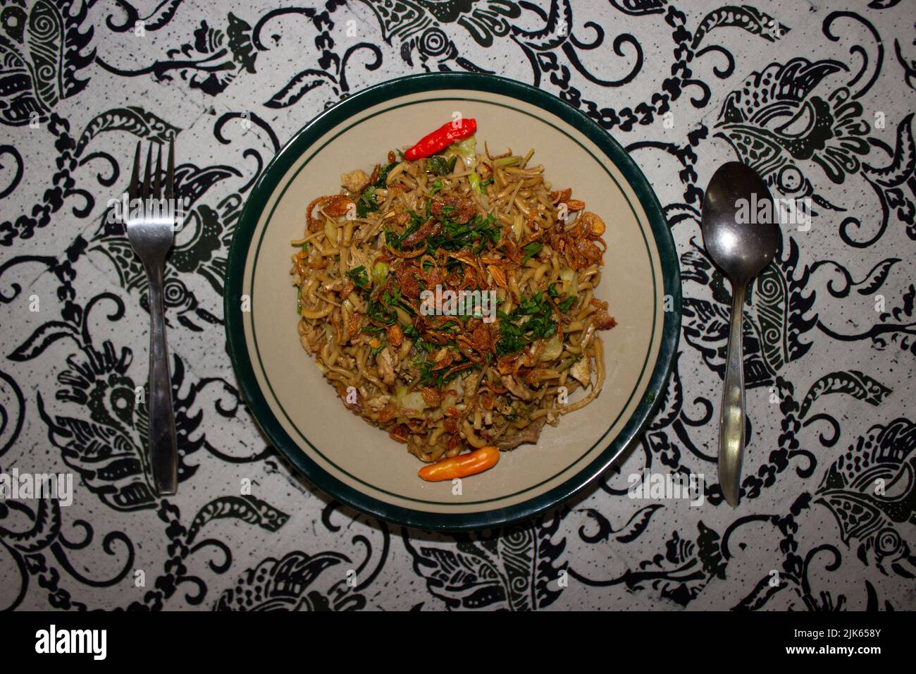 Mie Goreng Jawa or bakmi jawa or java noodle with spoon and fork ...