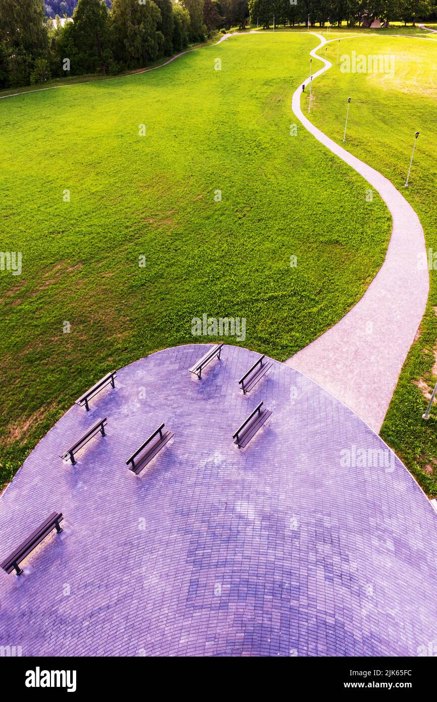 Stone pavement in the form of a circle surrounded by green grass ...