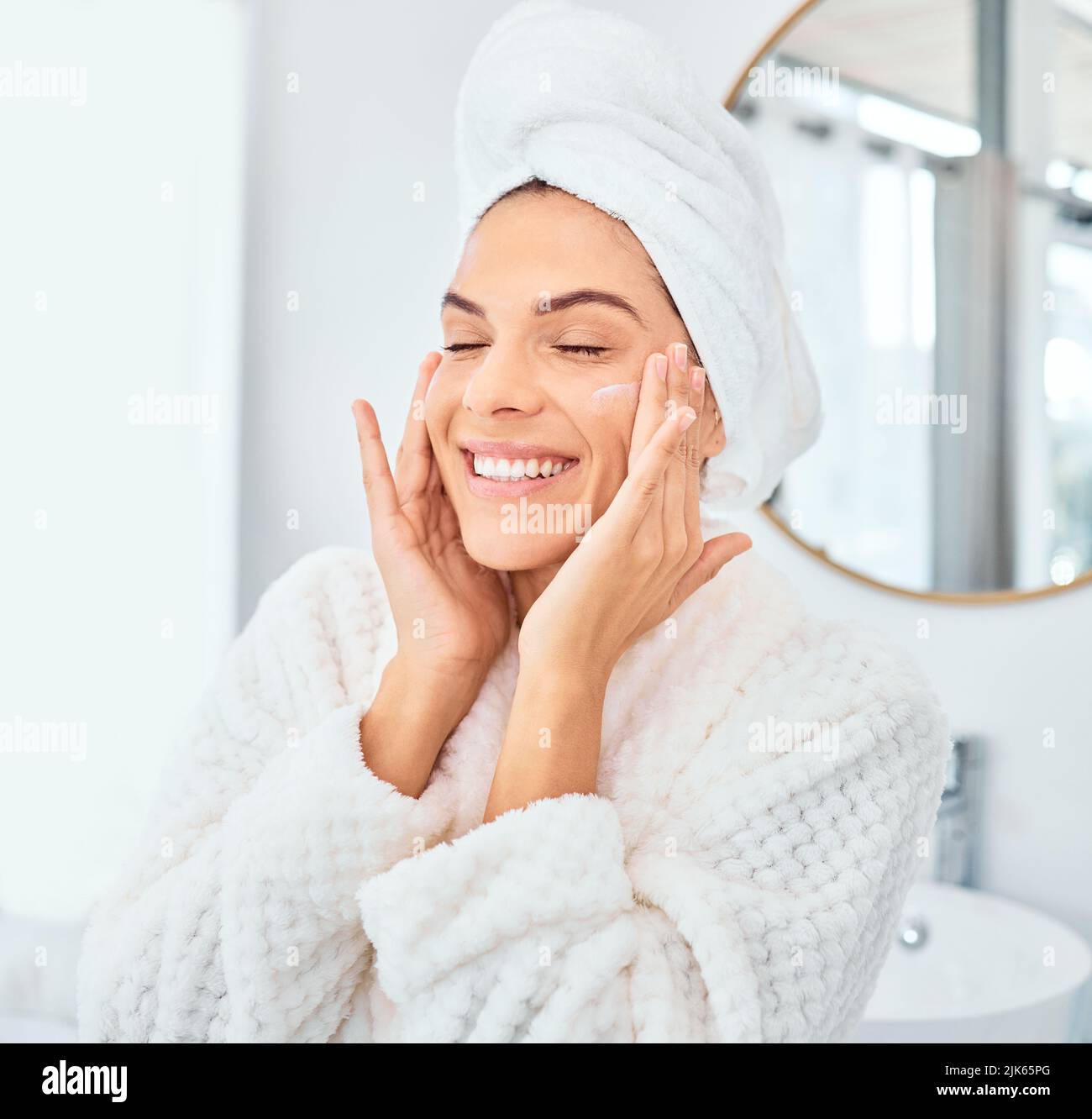 This moisturiser feels deeply hydrating. a young woman applying ...