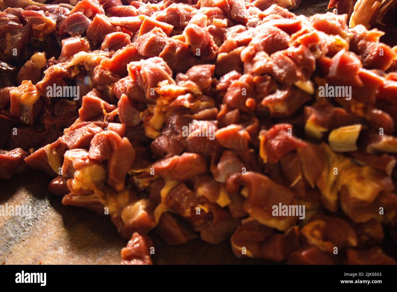 Traditional cooking raw meat with yellow curry or Tongseng in pan ...