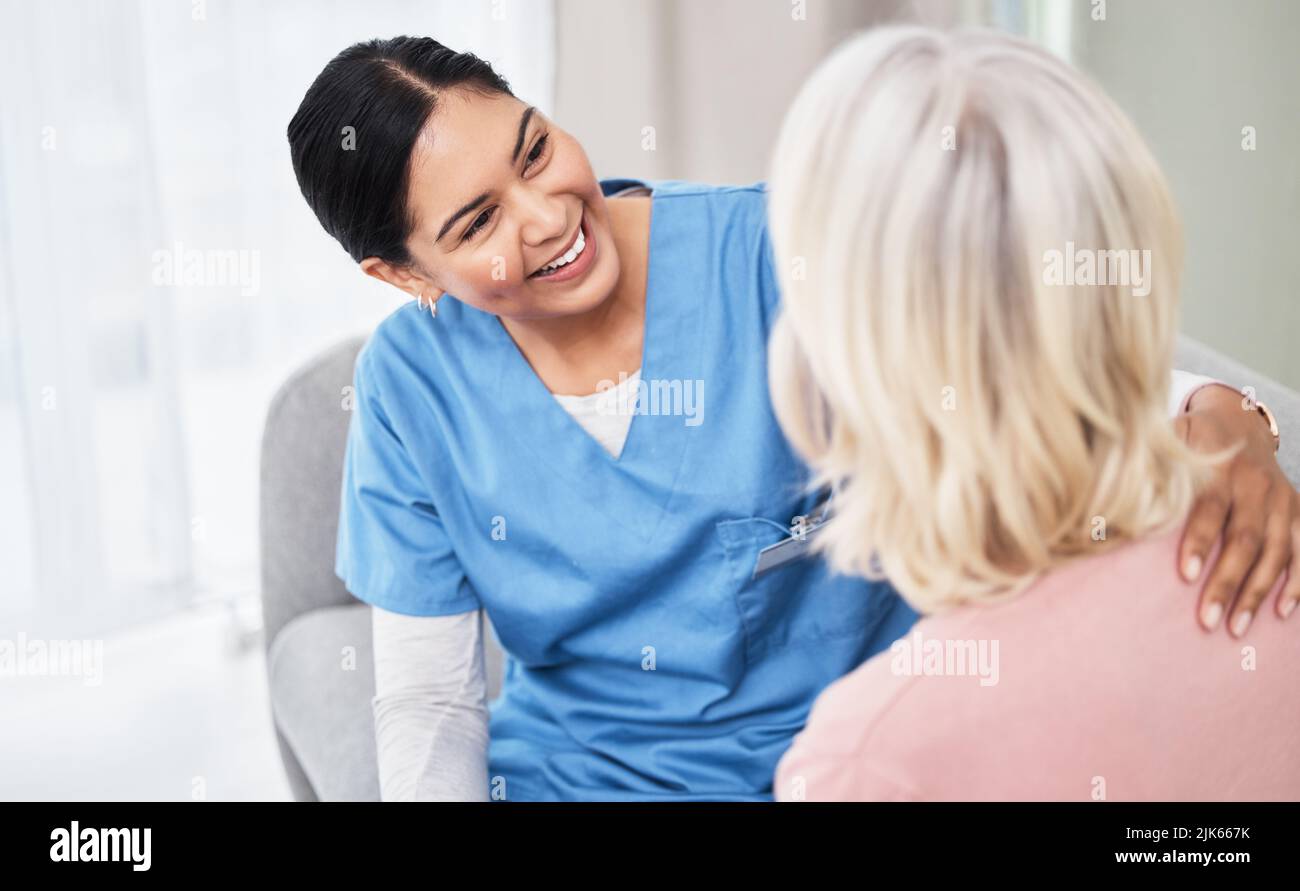 Im so happy that youre feeling better. a female nurse smiling while ...