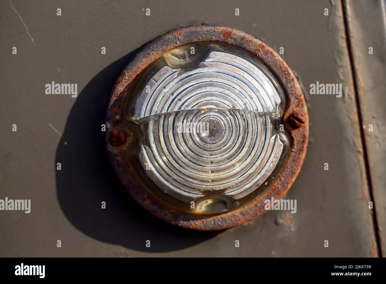 an old rusty light bulb on a car, an old light bulb and glass to ...