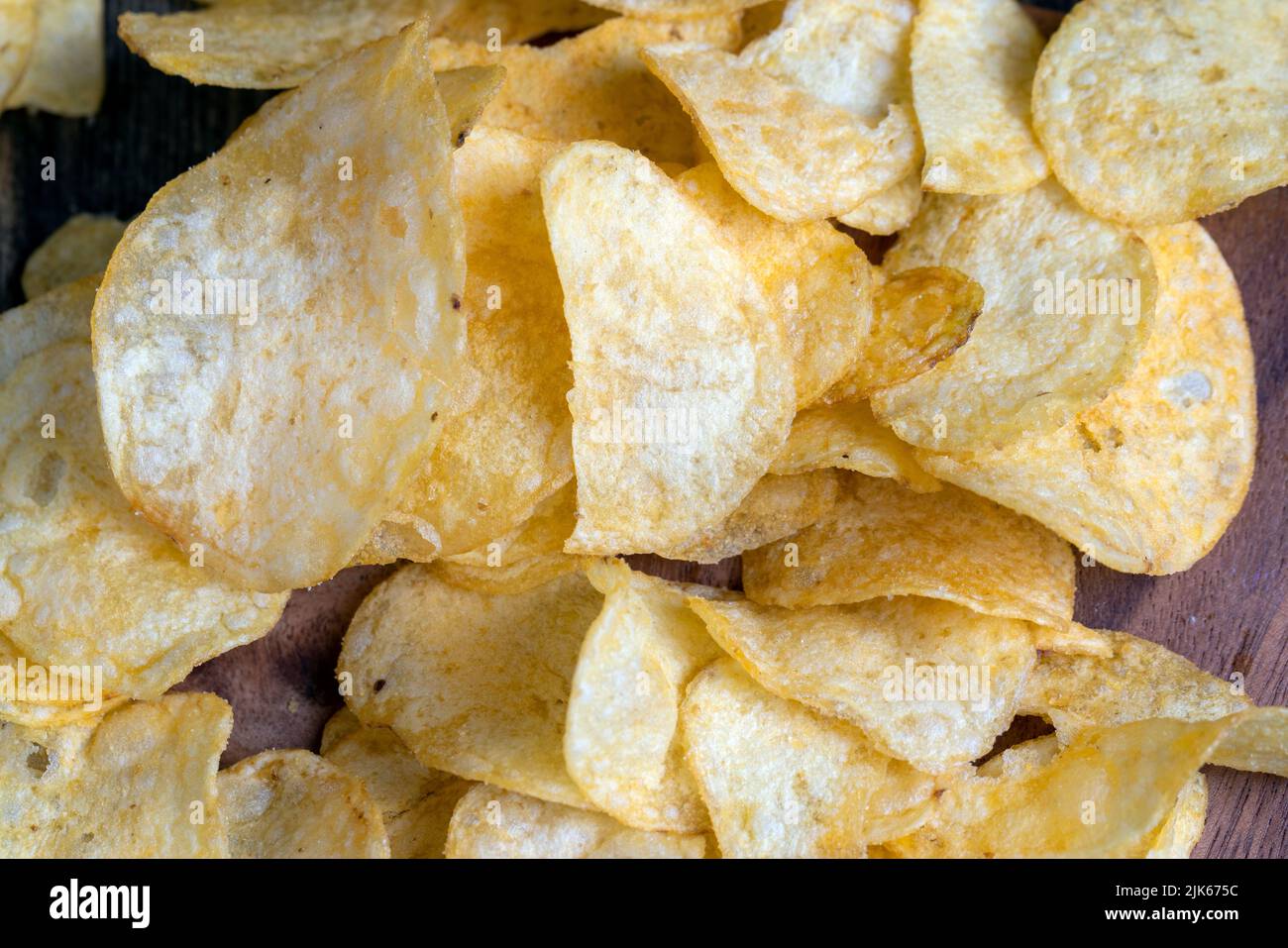 scattered potato chips with natural spices , fried potato chips with ...