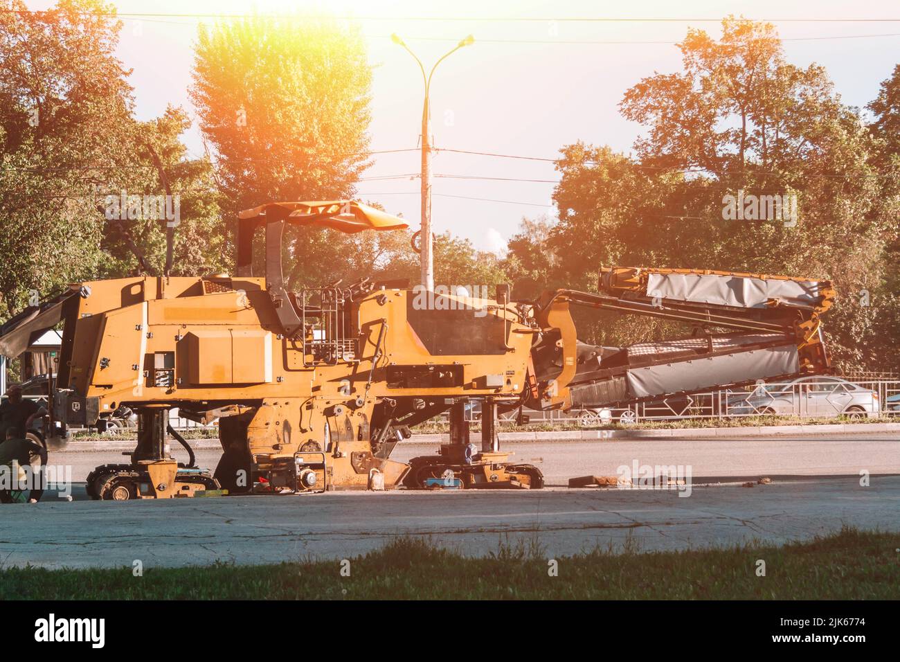 Road works. Workers repair the asphalt pavement of the road. Road ...