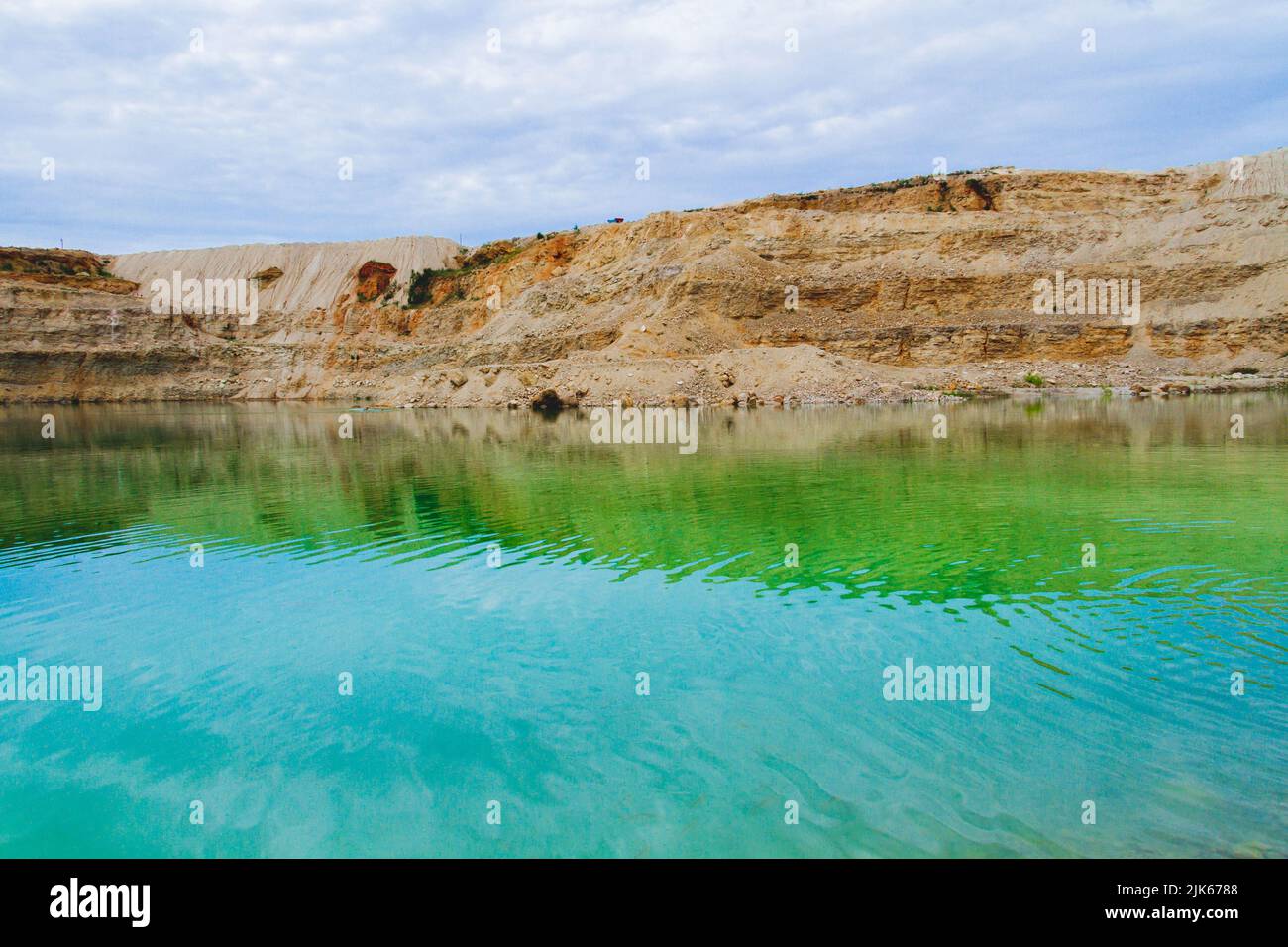 Lake formation in an old abandoned quarry. Quarry lake. Crushed stone ...