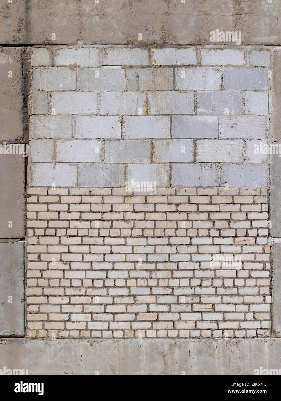 an old brick wall made of a large number of different types of bricks ...