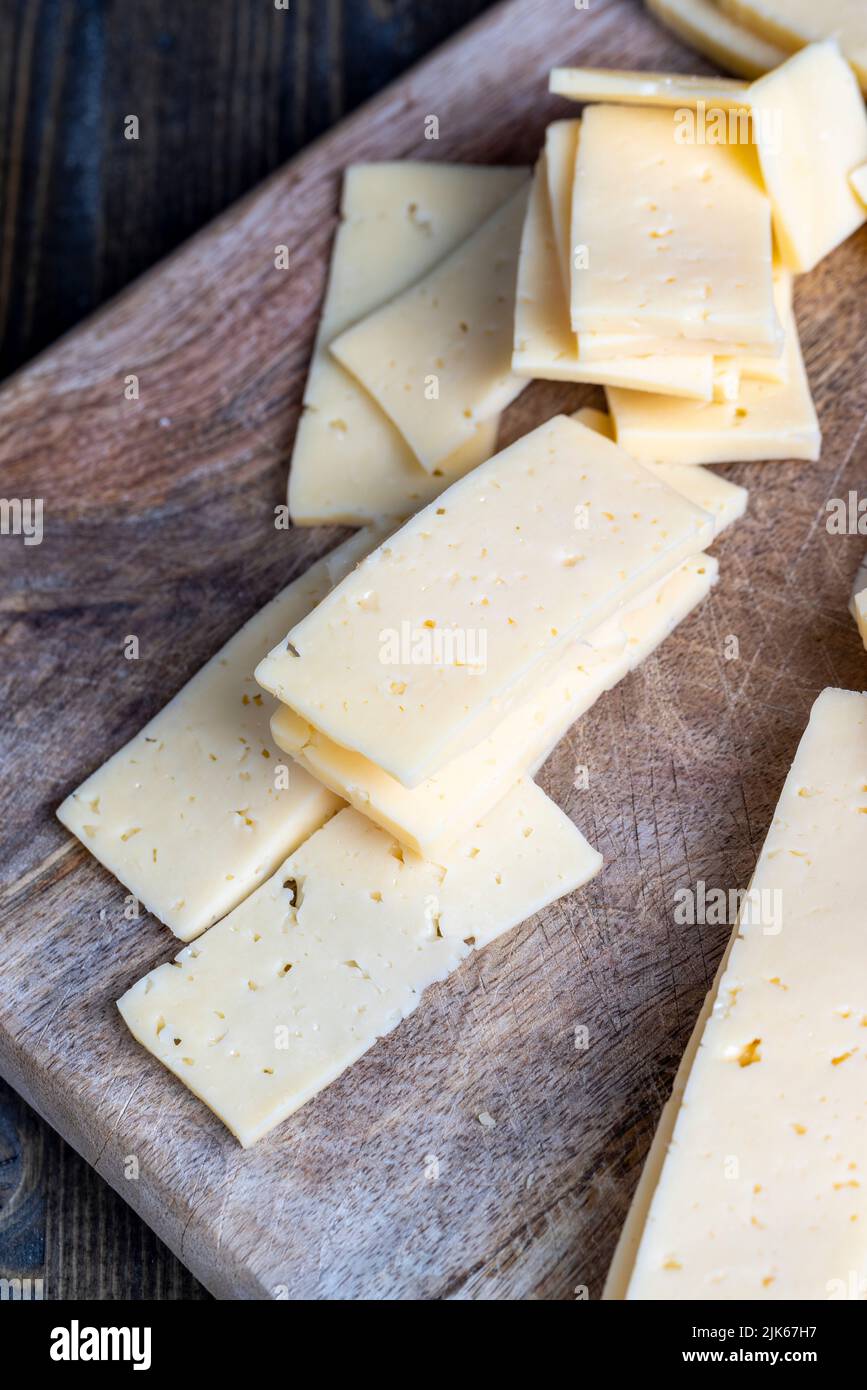 cut into pieces real hard cheese with lots of milk, the product of milk ...