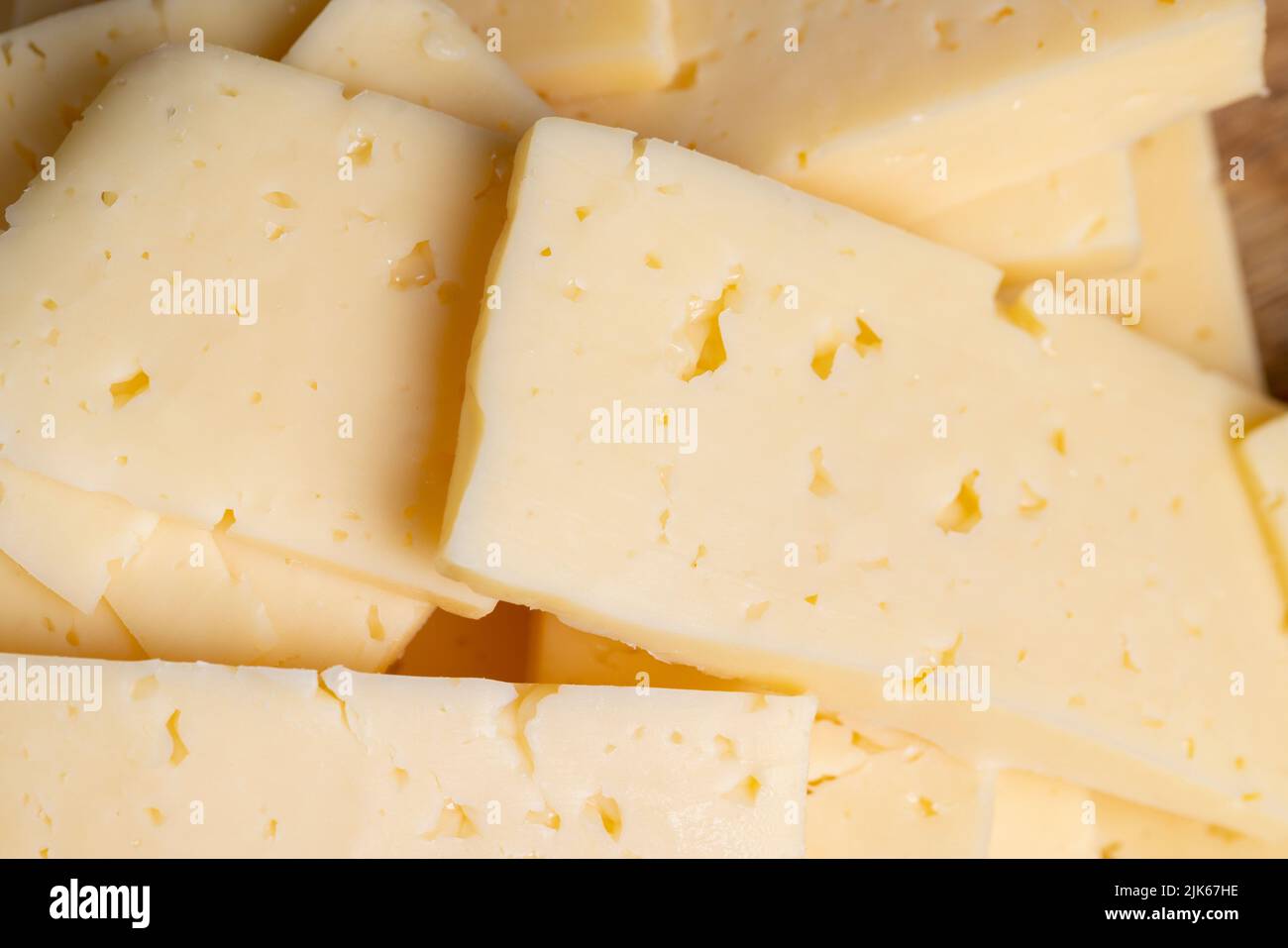 cut into pieces real hard cheese with lots of milk, the product of milk ...