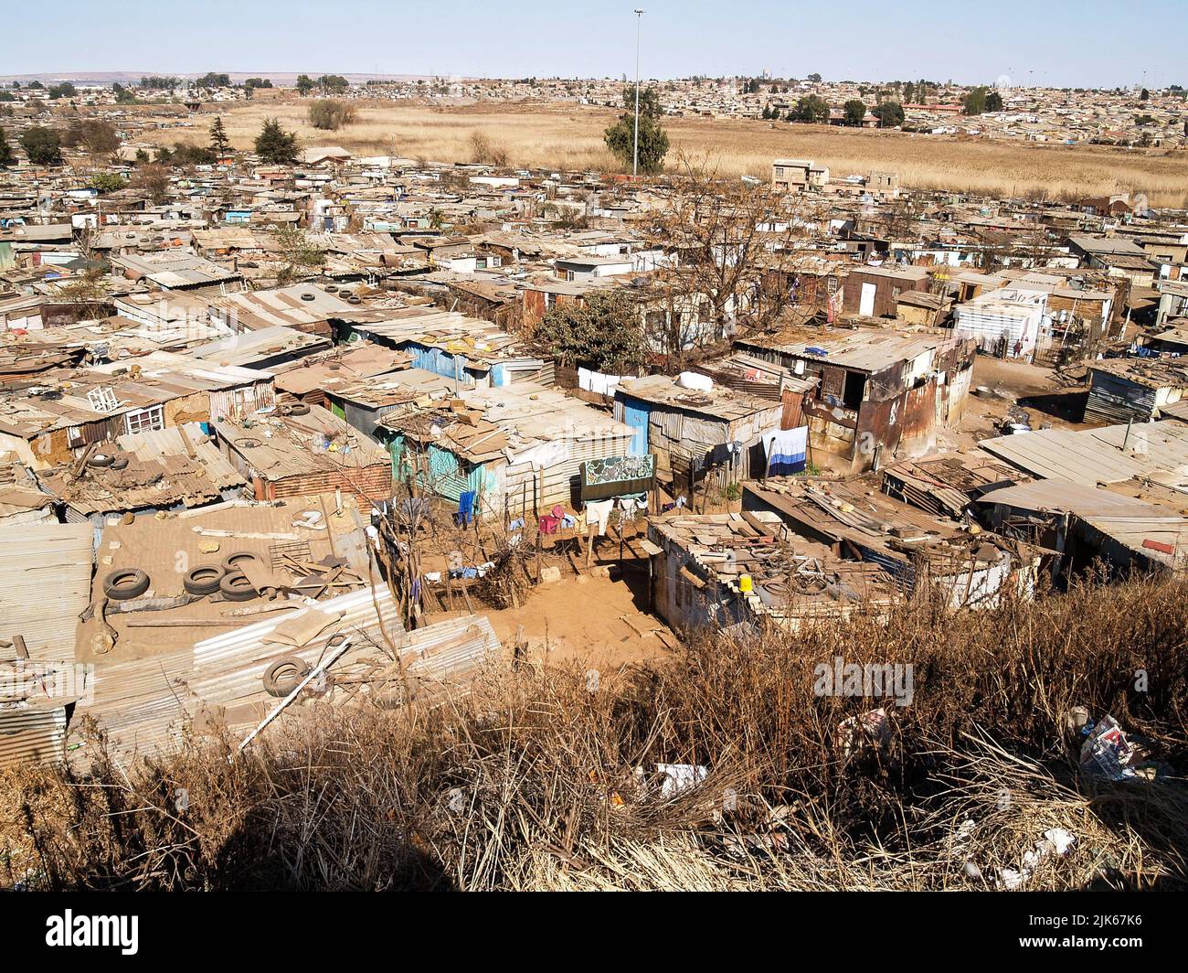 Rusting corrugated iron structures crammed into slum village in Soweto ...