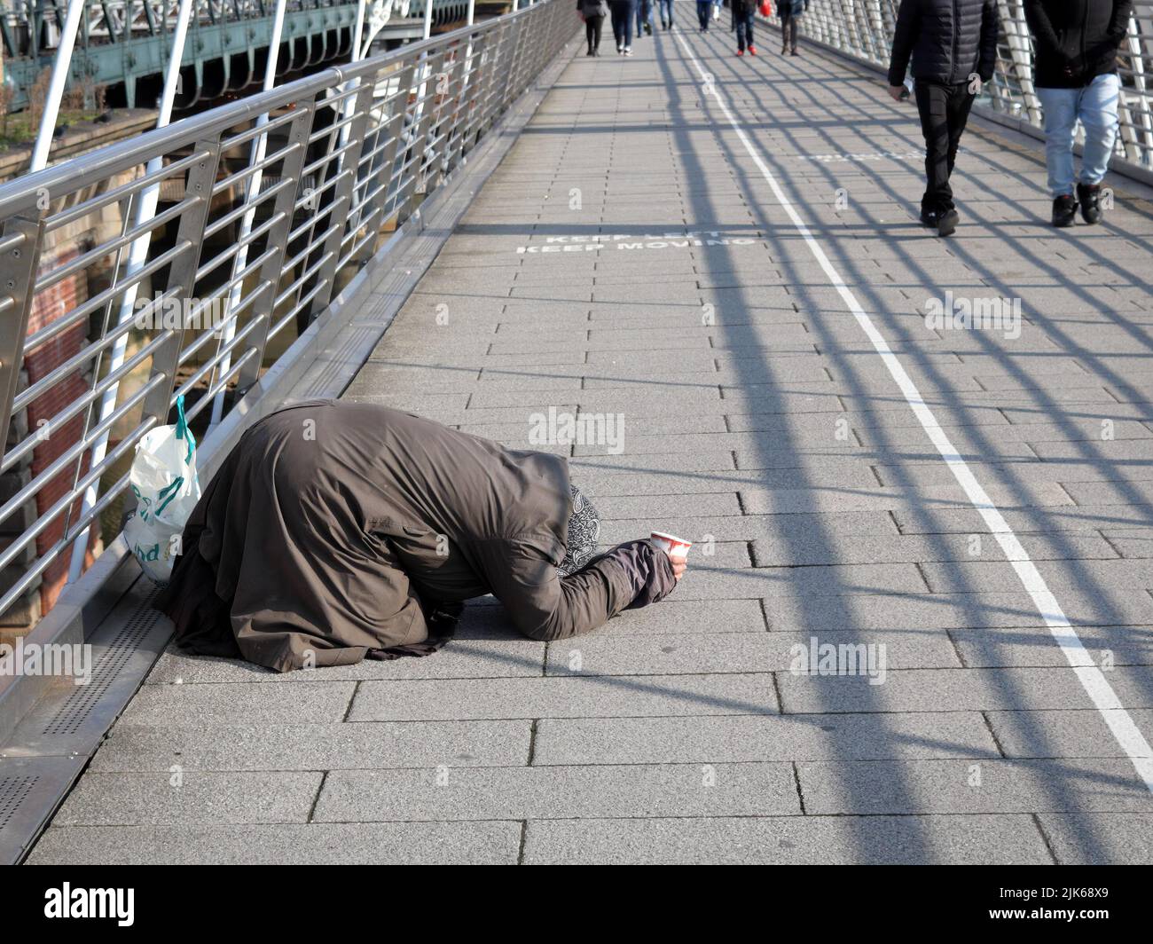 London, UK - Mar 07, 2021: elderly poor woman begging for money on ...