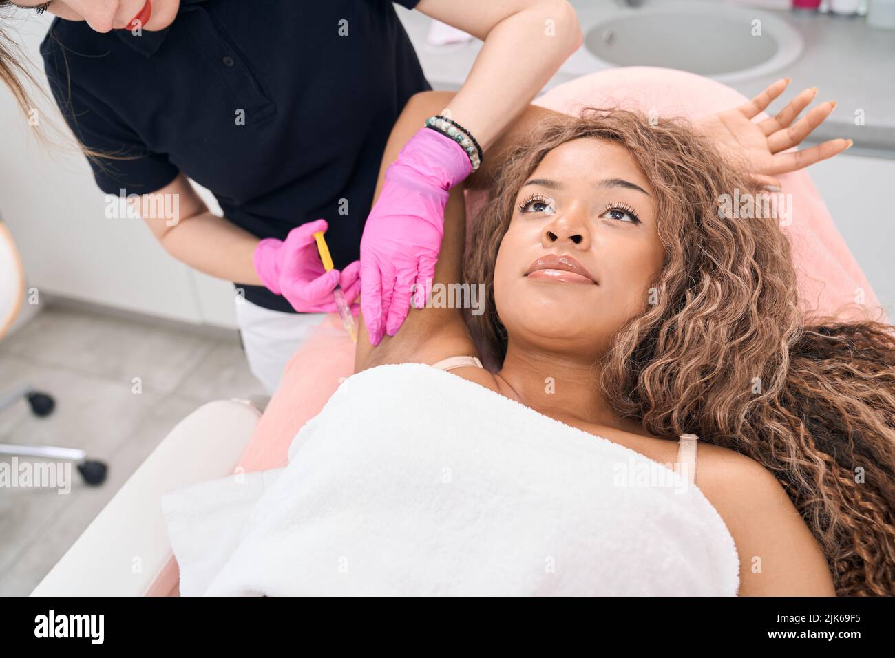 Doctor performing injection procedure in aesthetic medicine clinic ...