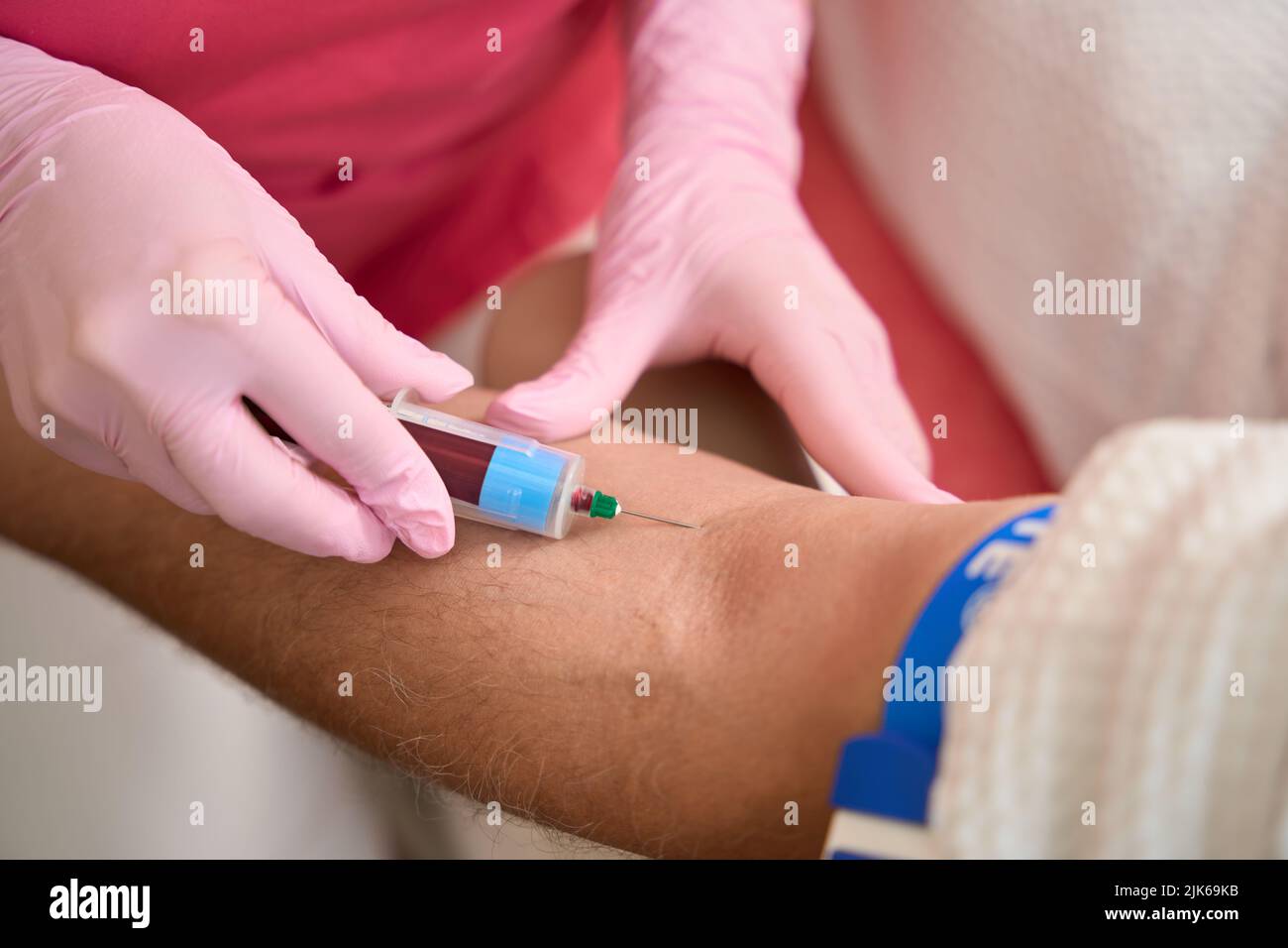 Female hands nurse take blood test from man vein Stock Photo - Alamy