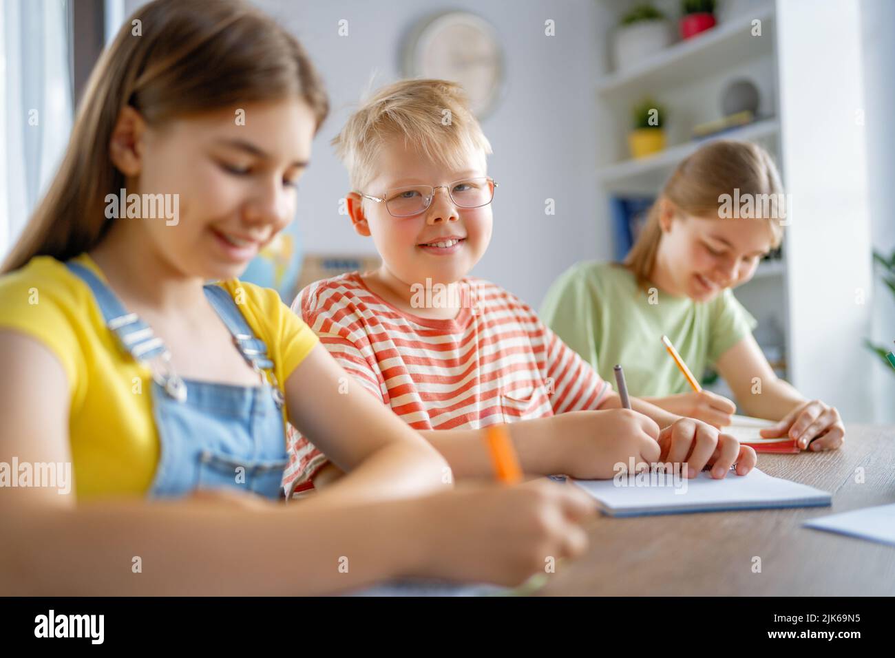 Happy kids at school. Children are working in the class Stock Photo - Alamy
