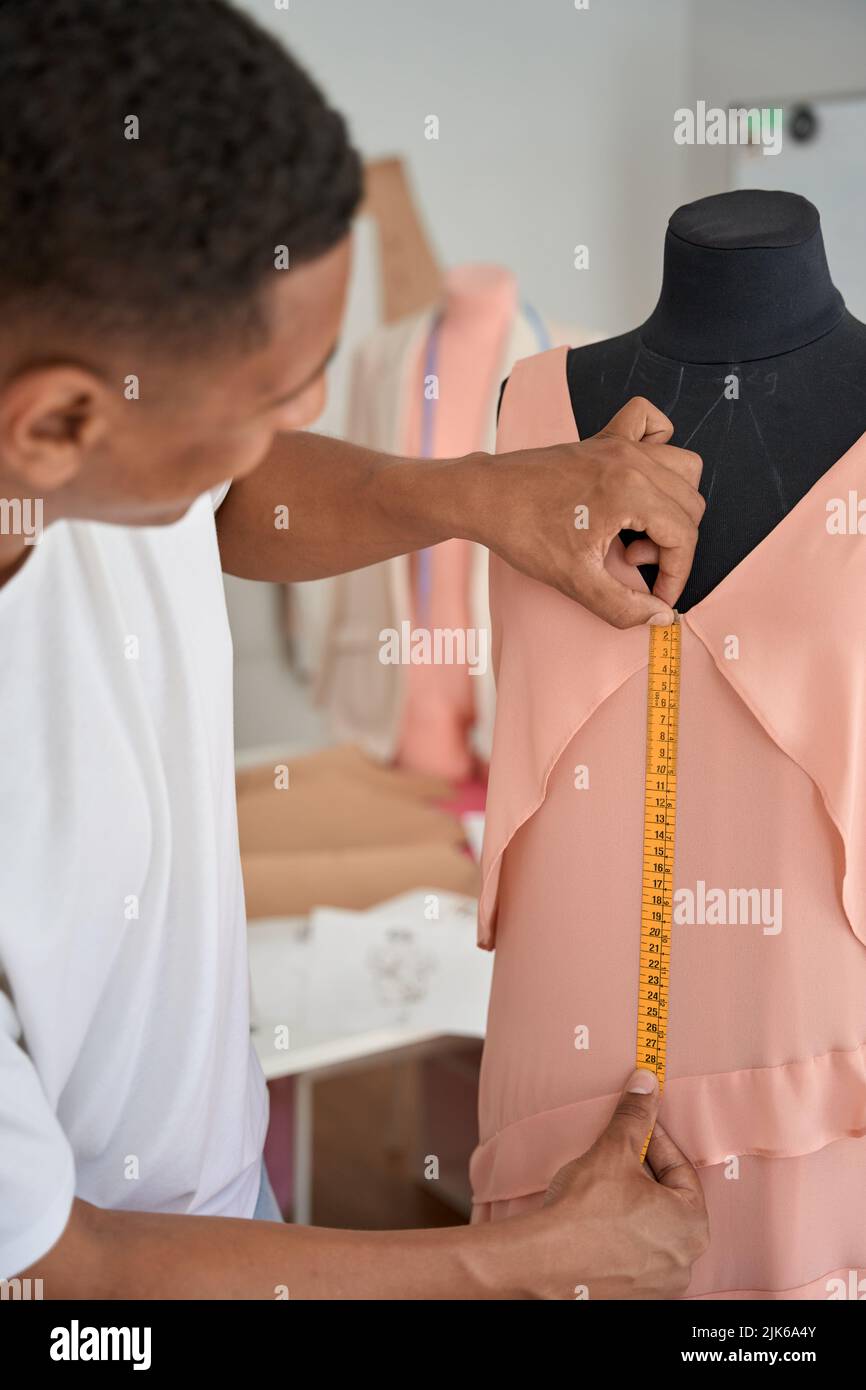 African American tailor measuring female dress in atelier Stock Photo ...