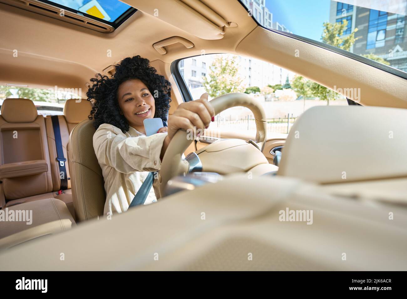 Female drives a comfortable car and talks on the phone Stock Photo - Alamy