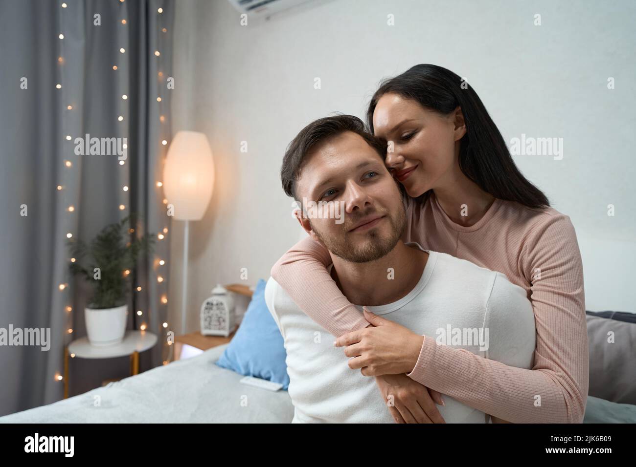 Family photo session of a young couple in the bedroom Stock Photo - Alamy