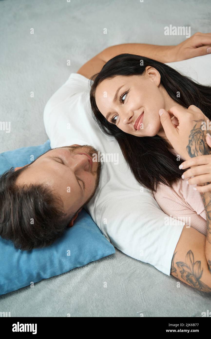 Woman hugs man on bed hi-res stock photography and images - Alamy