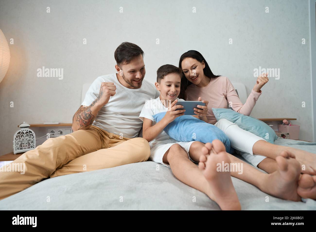 Friendly dad, mom and son spend time together Stock Photo - Alamy