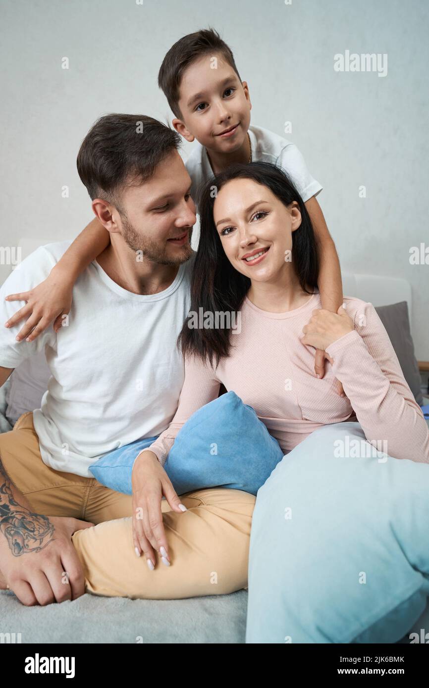 Teenage son lovingly hugging glorious smiling parents Stock Photo - Alamy