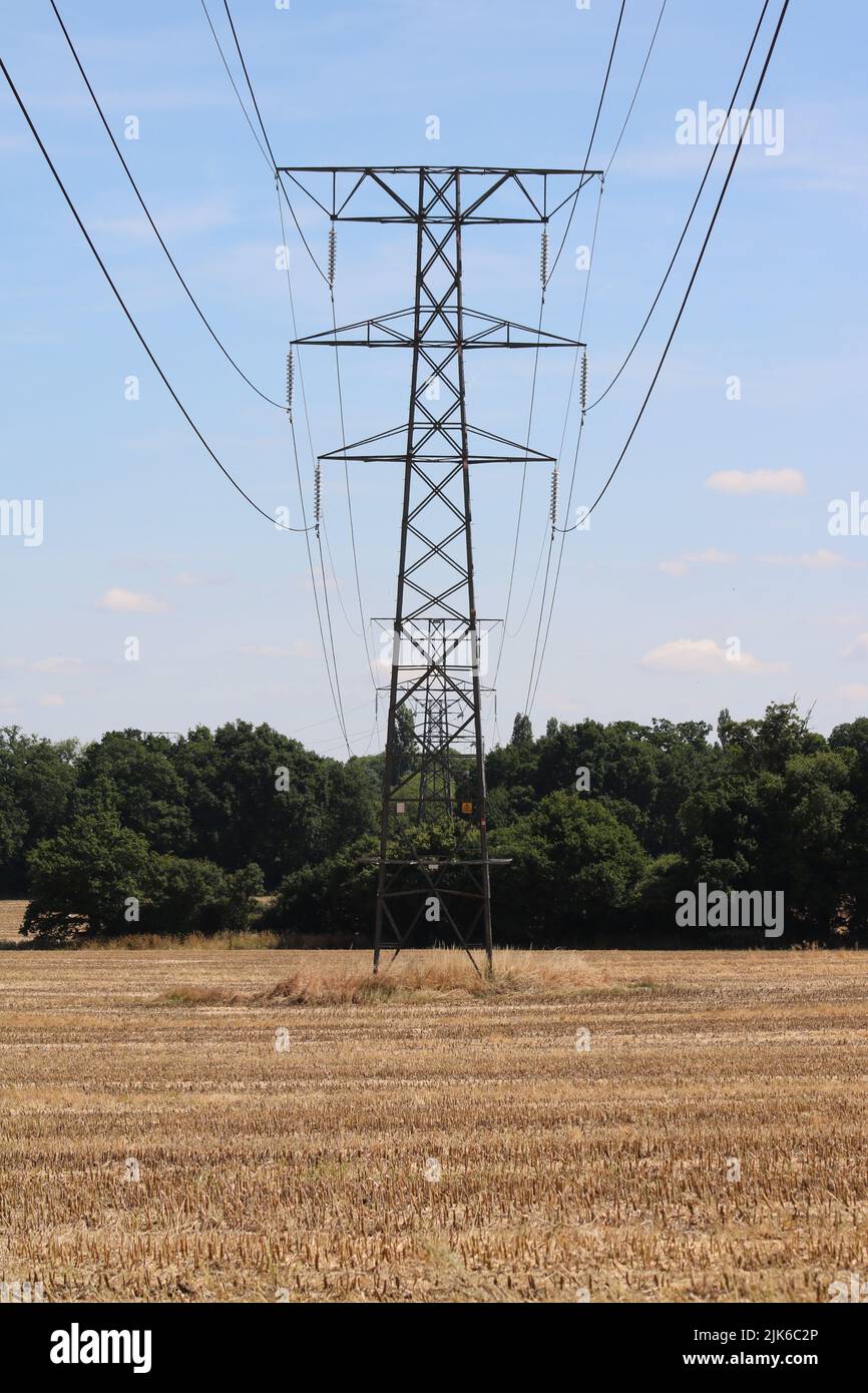 Vertical image of electricity pylon and wires against blue sky Stock ...