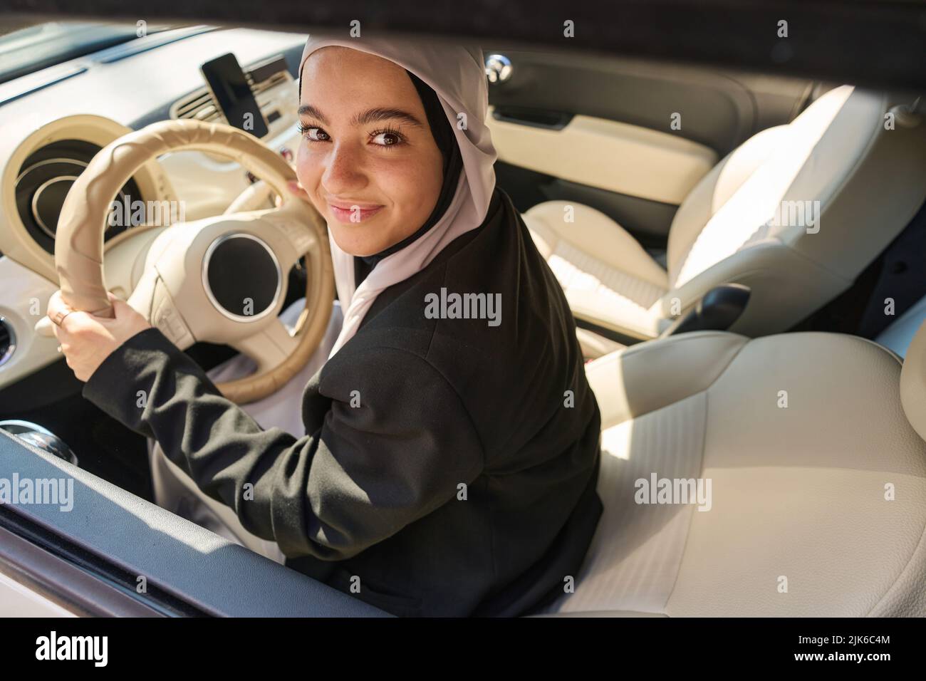 Arab woman driving a car with the driver's seat reclined Stock Photo ...