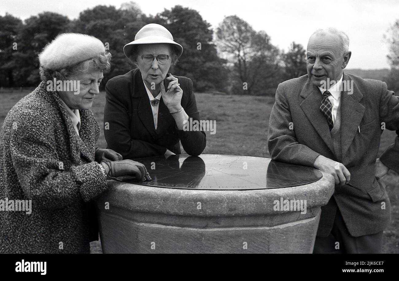 1960s, historical, outside in a park, three well-dressed elderly people ...