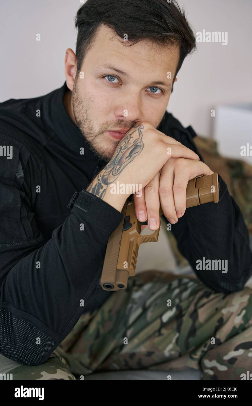 Ukrainian man soldier with sidearm staring into camera Stock Photo - Alamy