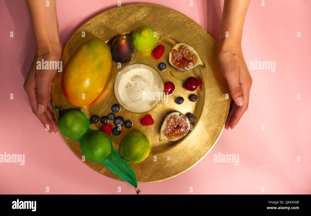 Woman's hands serve a beautifully served plate, platter of fresh ...