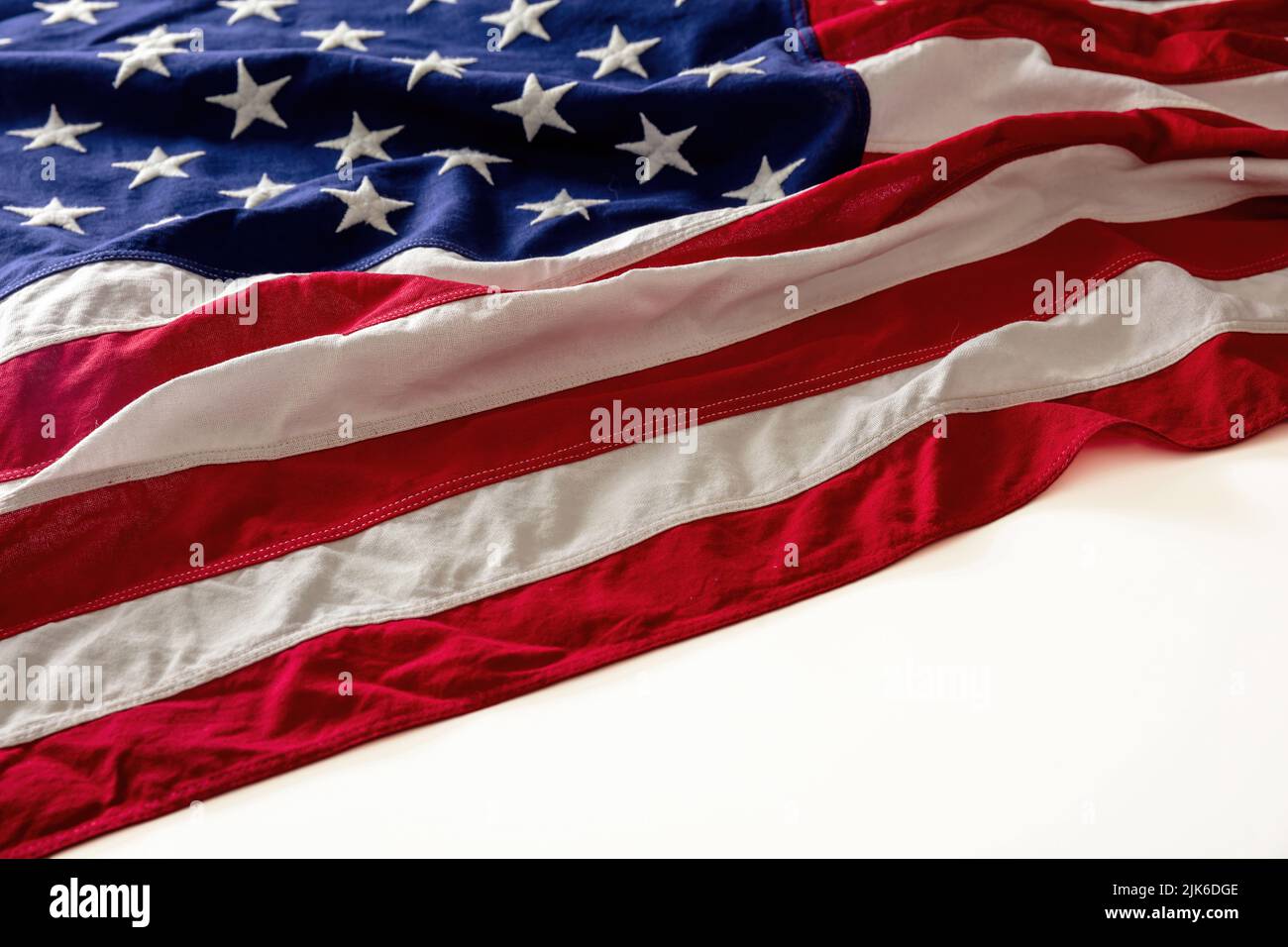 USA flag rippled on white background, copy space. National American ...