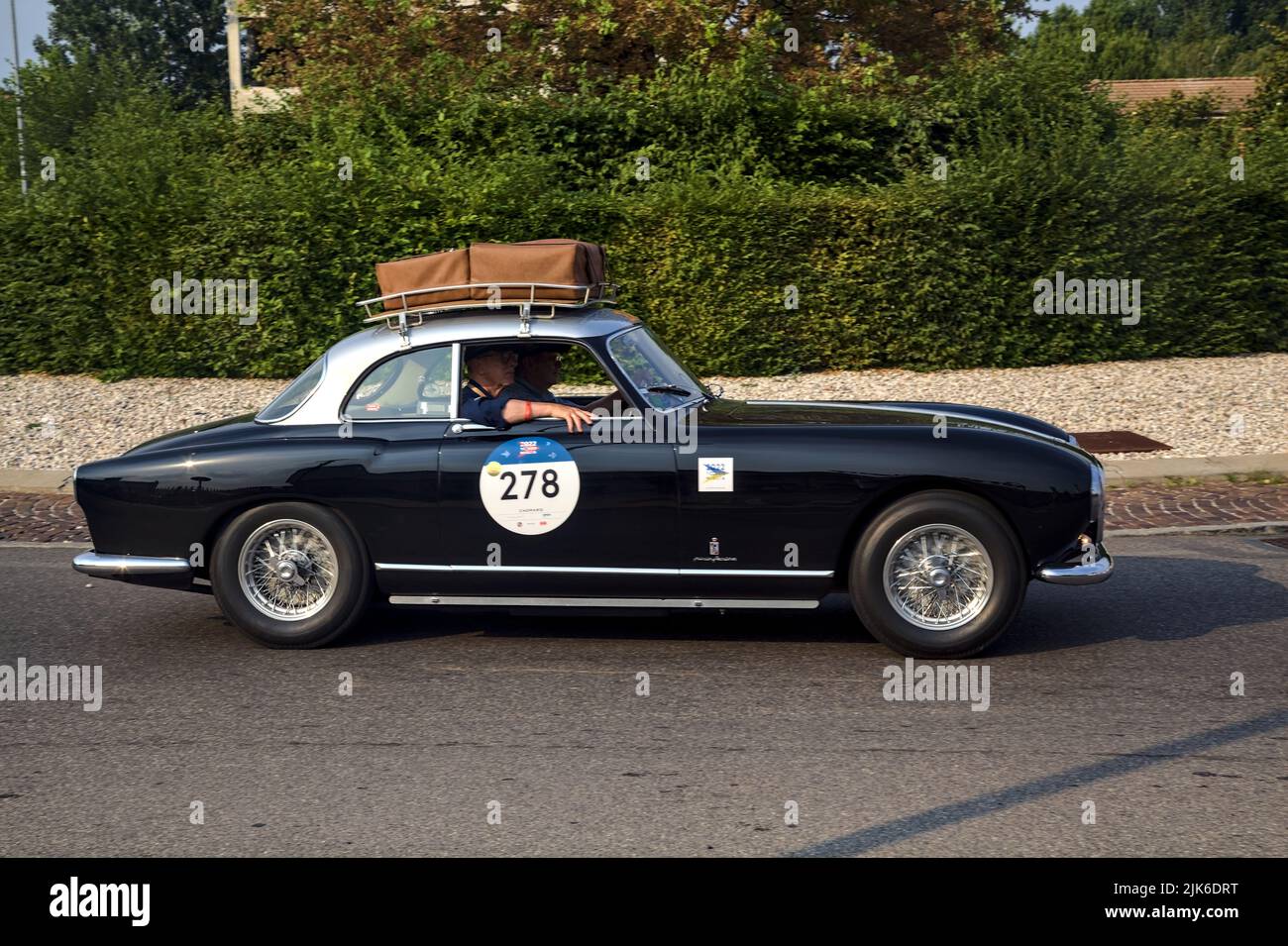 Historic car on a roundabout seen sideways Stock Photo - Alamy