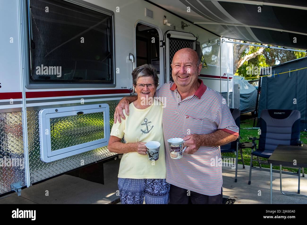 Happy retired couple camping with their luxury caravan at Mudjimba ...