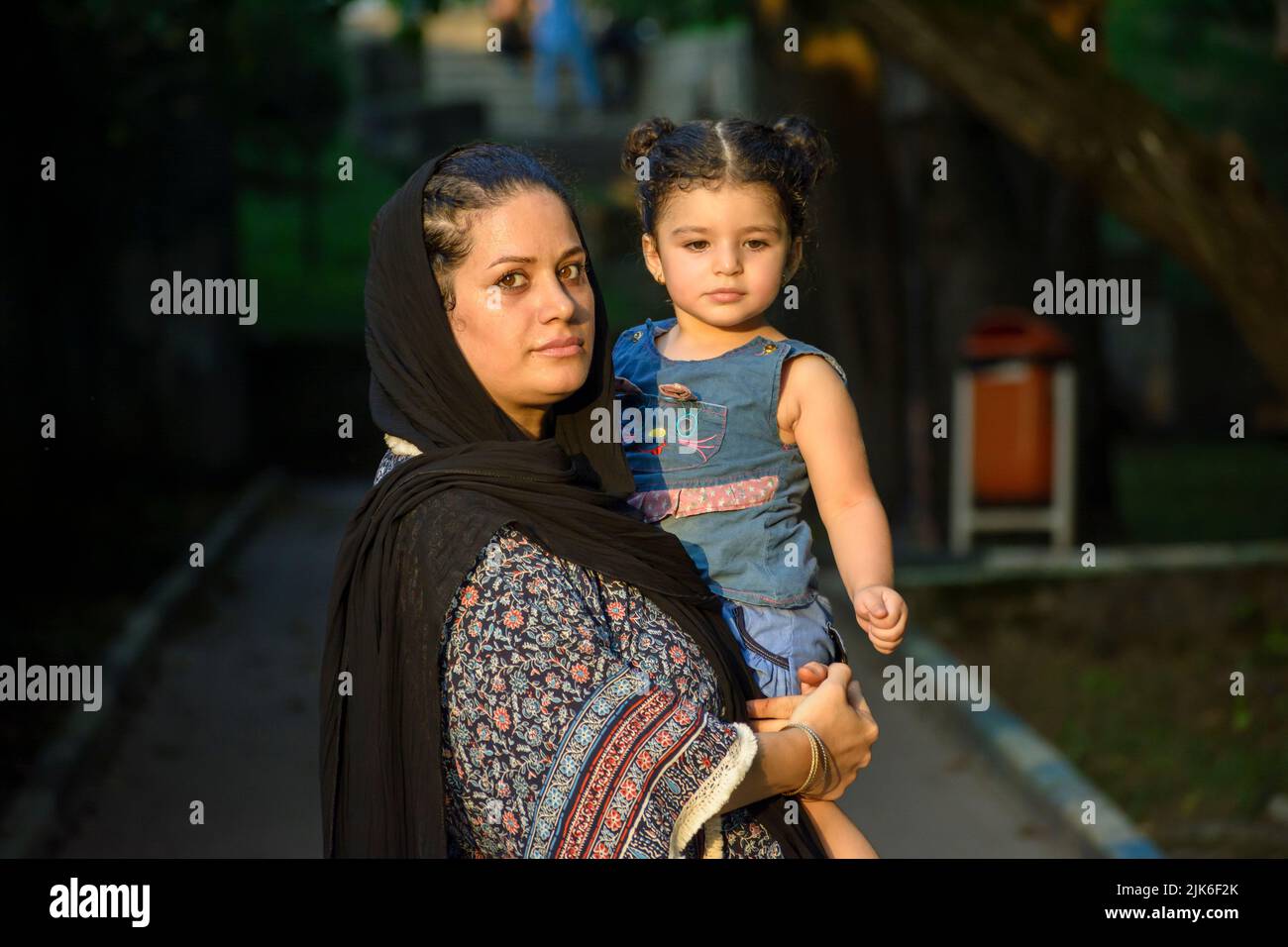 Young mother with her two years girl in her hug , Muslim family at ...