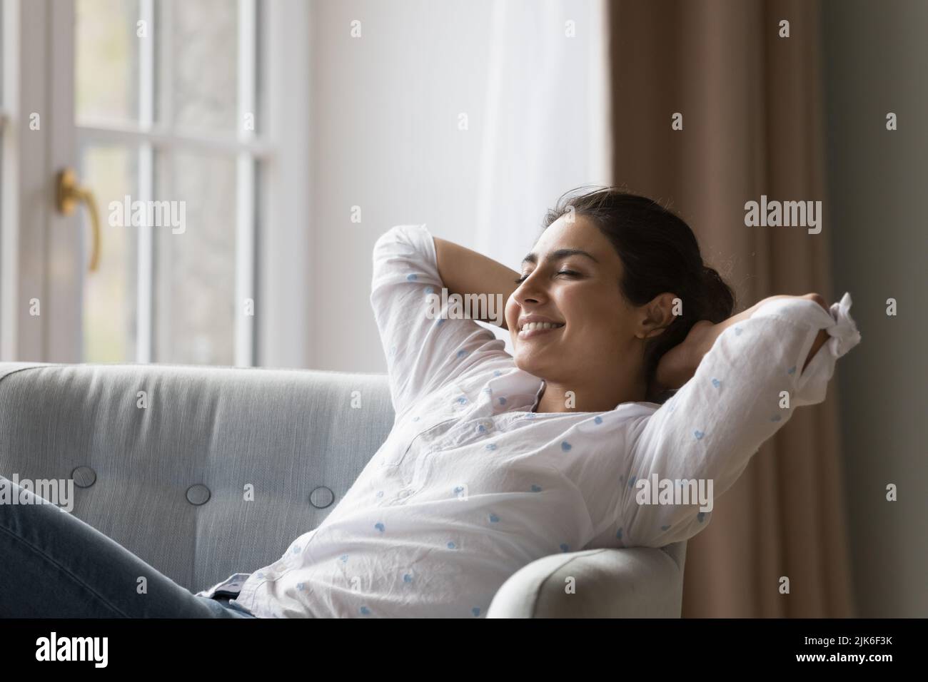 Cheerful pretty young Indian woman enjoying leisure, lazy break Stock ...