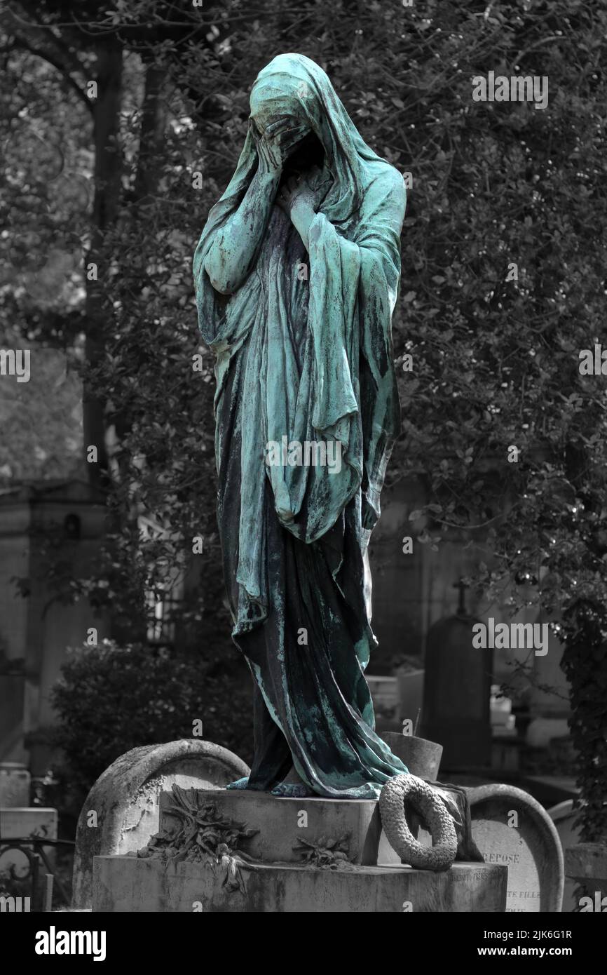 Paris, France - June 21, 2019: Statue of mourning woman in cemetery ...
