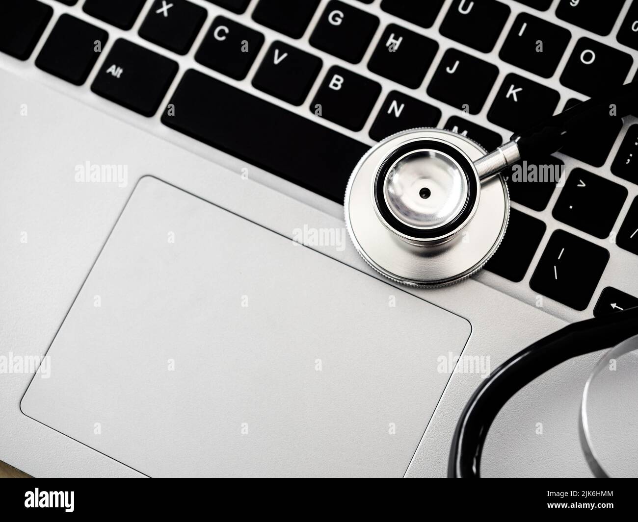 Close up stethoscope on keyboard and touchpad on laptop computer ...