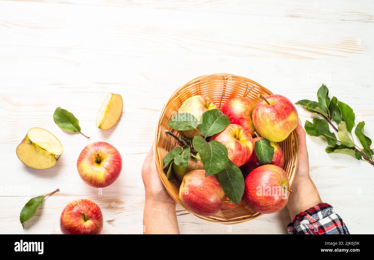 Fresh ripe red apples in the basket at white table Stock Photo - Alamy