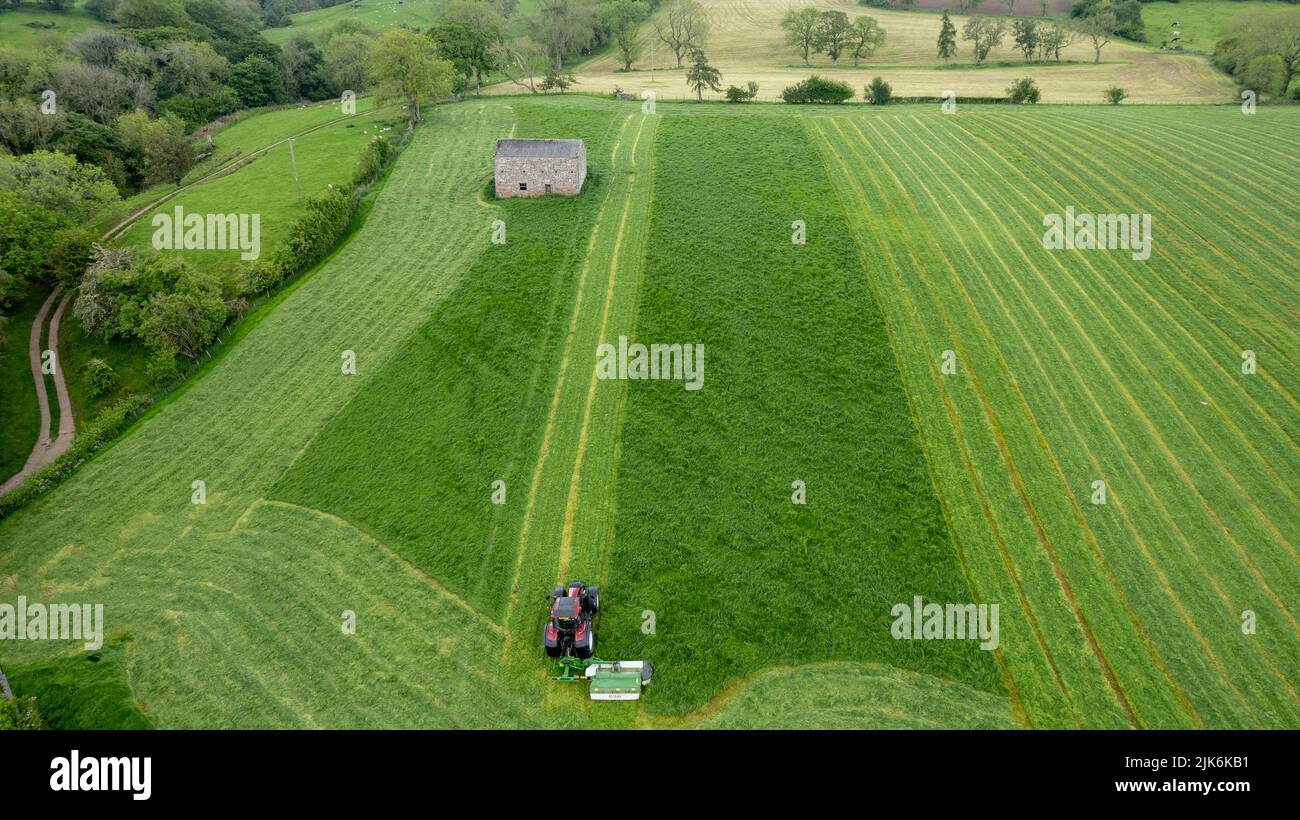 Mowing a crop of grass on a farm in the Eden Valley near Kirkby Stephen ...