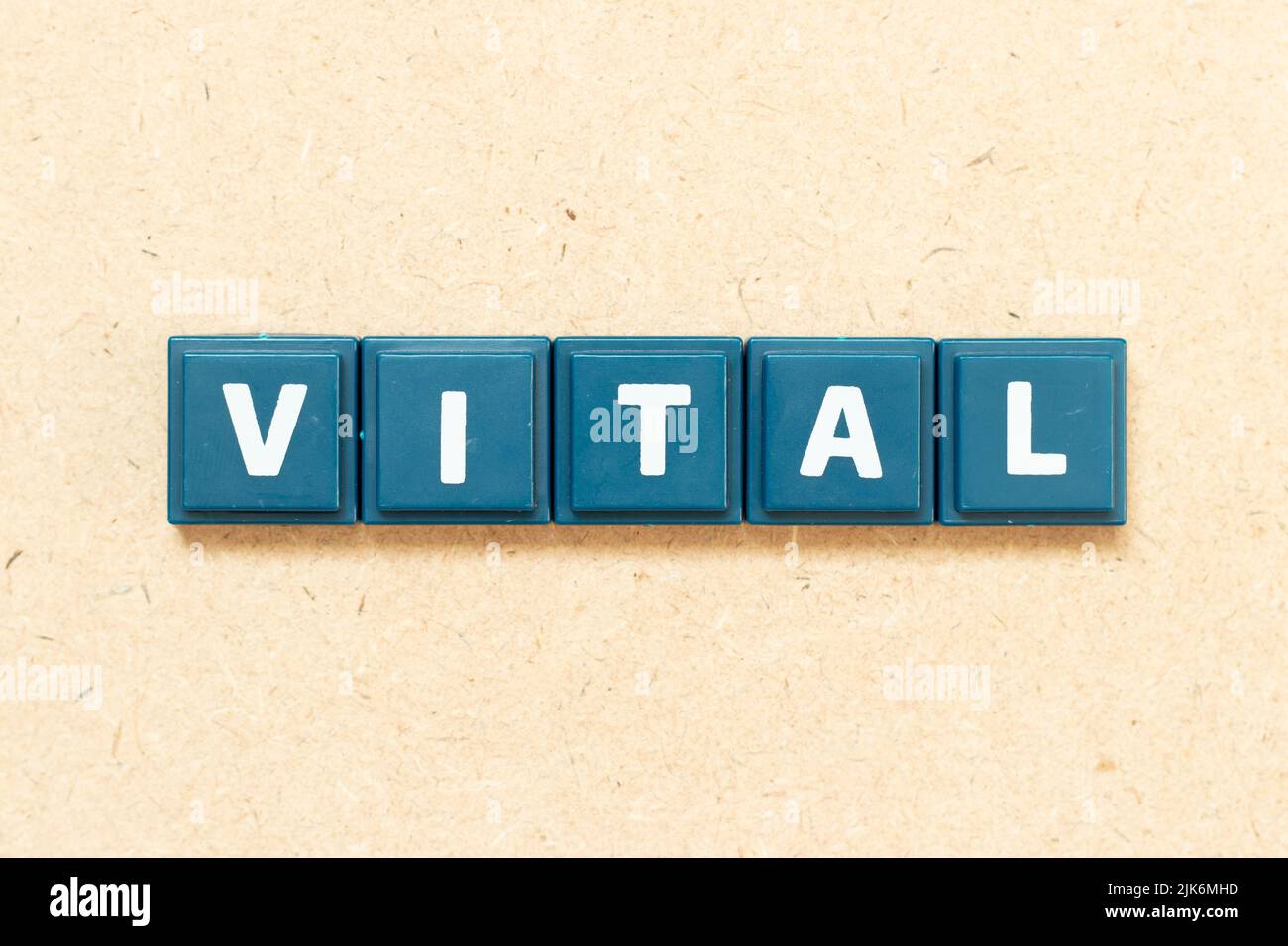 Tile alphabet letter in word vital on wood background Stock Photo - Alamy