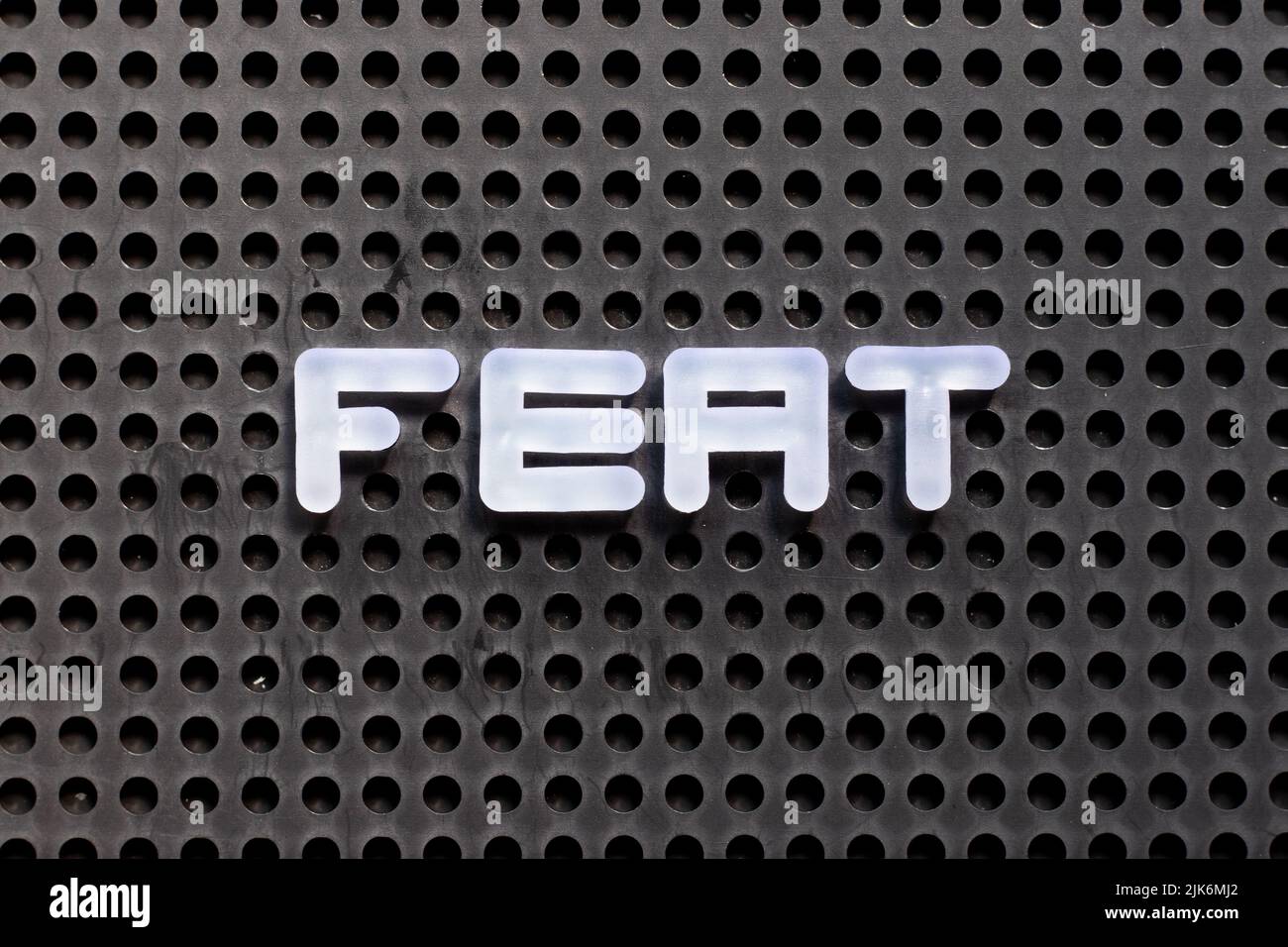 White color letter in word feat on black pegboard background Stock ...