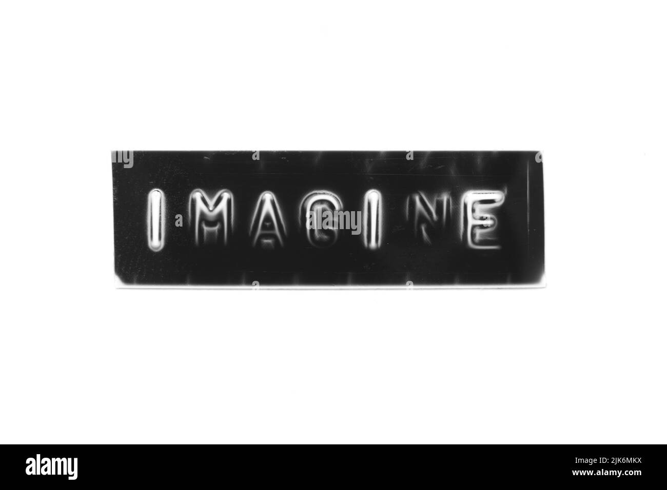 Black color banner that have embossed letter with word imagine on white ...
