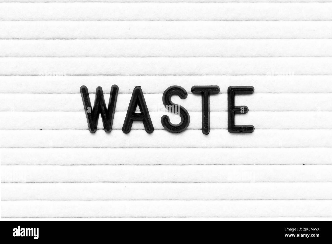 Black color letter in word waste on white felt board background Stock ...