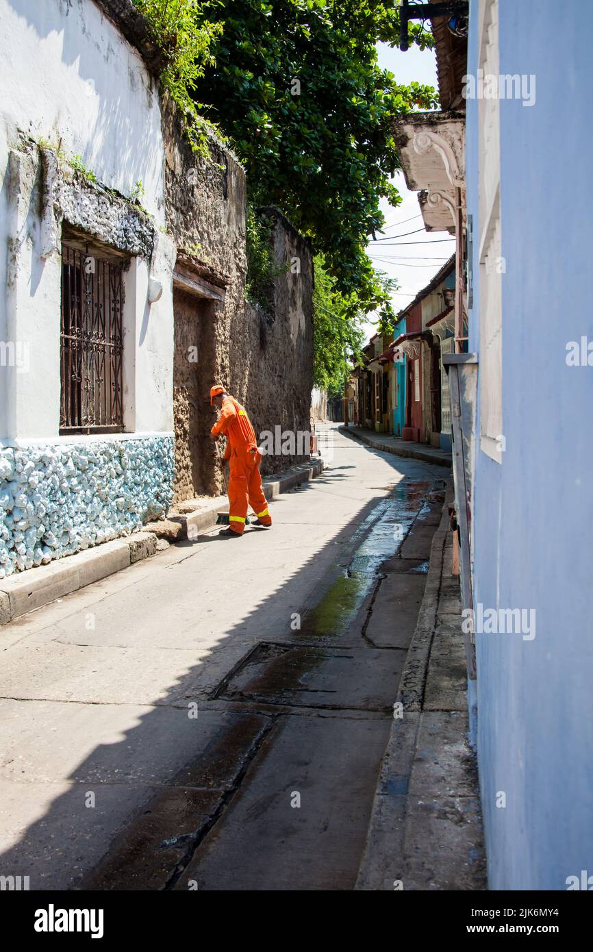 CARTAGENA DE INDIAS, COLOMBIA - AUGUST, 2011: Street sweeper in orange ...