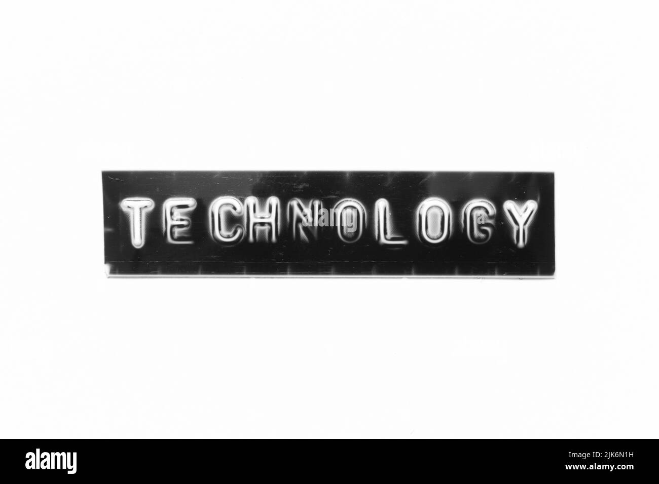 Embossed letter with word technology in black banner on white paper ...