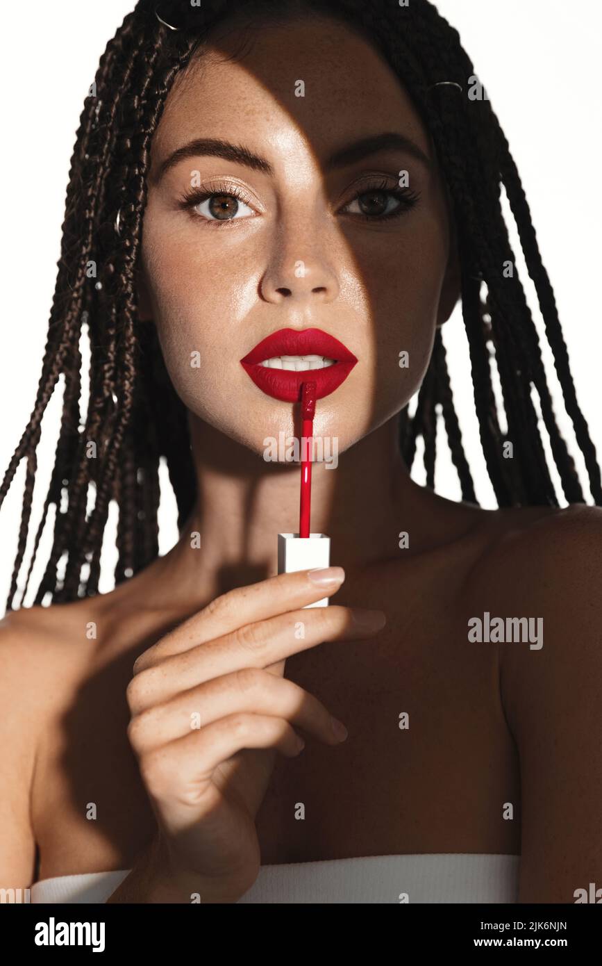 Sensual Woman Applies Lipstick On Her Lips Holds Red Gloss Has Half