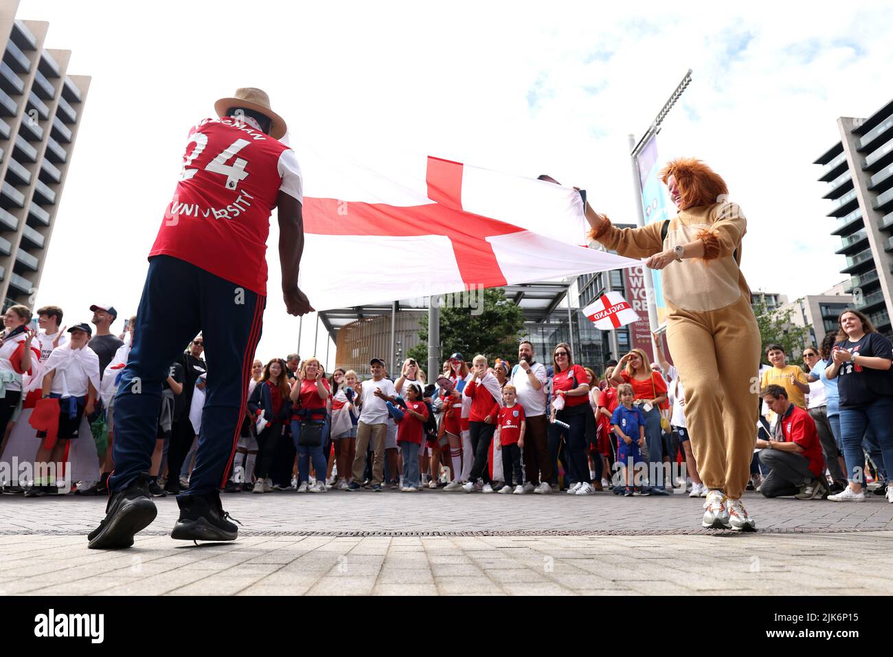 A fan wearing a lion costume flies a flag outside the stadium before ...